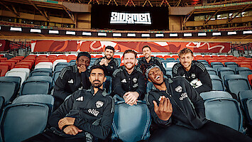Sidemen seated in the stands of a stadium.